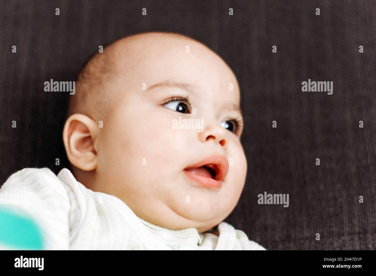 Sweet little baby boy with chubby cheeks and big eyes. Portrait of ...