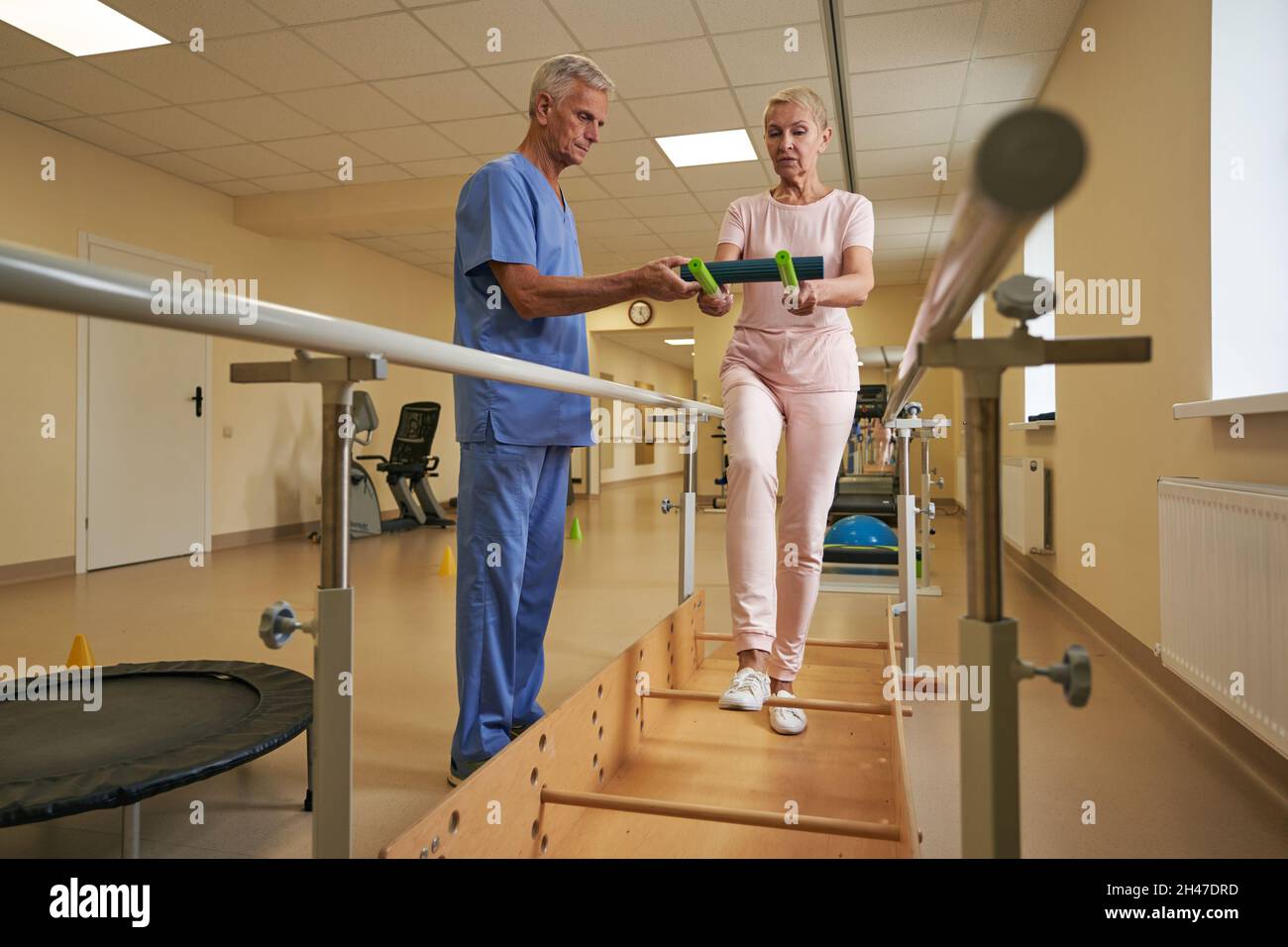 Physiotherapist with stroke patient during balance training in medical ...