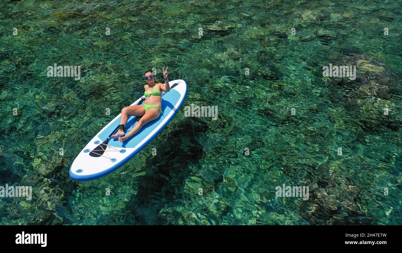 Sunbathing on paddle board hi-res stock photography and images - Alamy