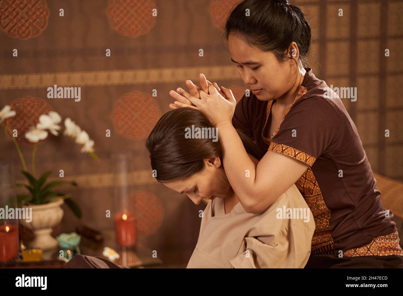 Female massotherapist treating young patient for cervicalgia Stock ...