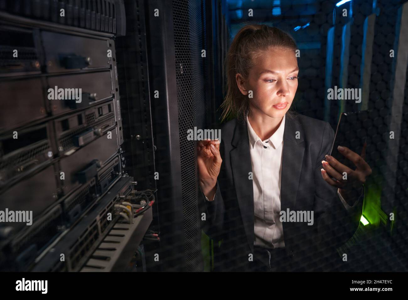 Photo of woman engineer at network equipment Stock Photo - Alamy