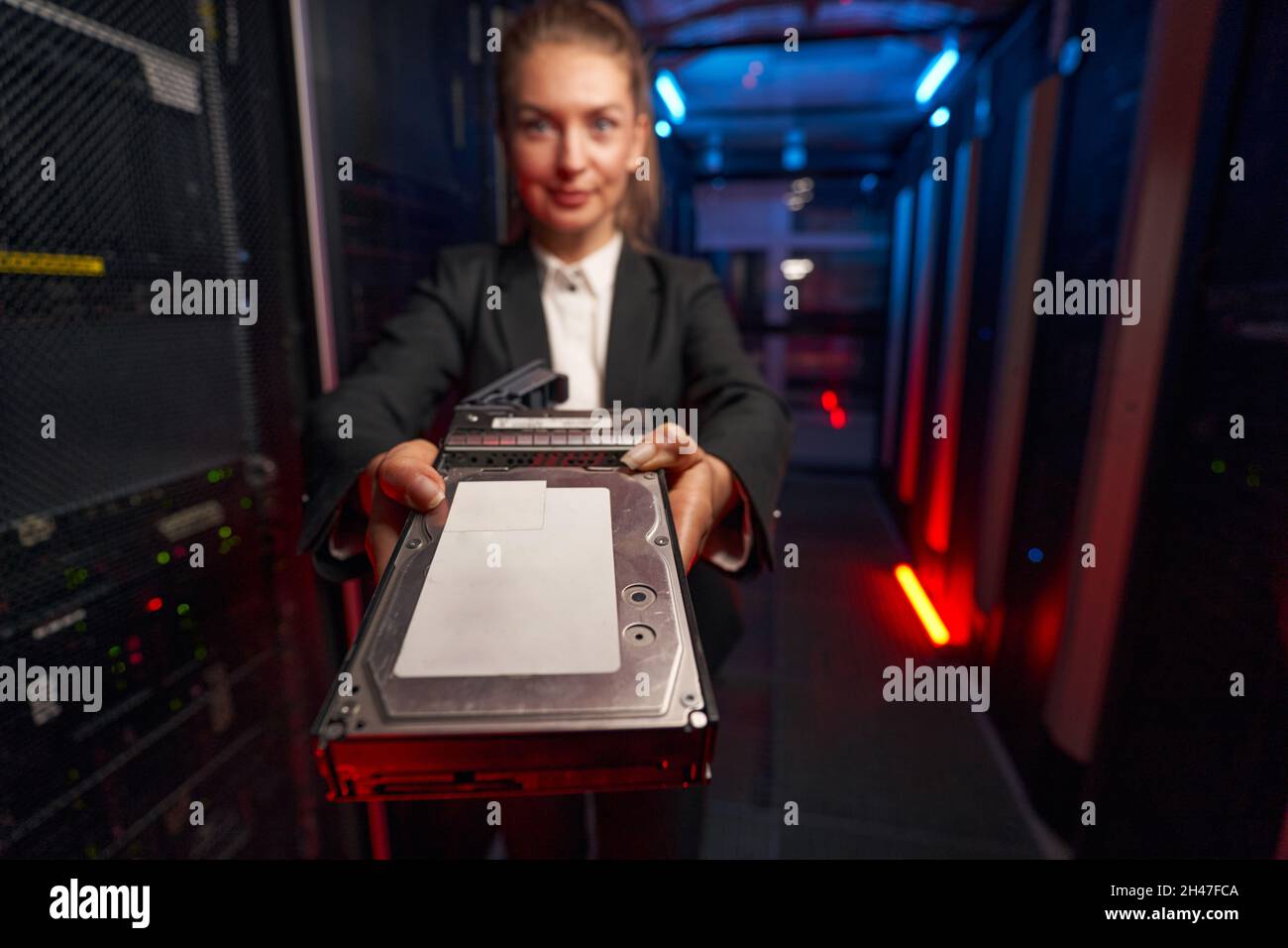 Female technician holding hard drive disk in data center Stock Photo ...