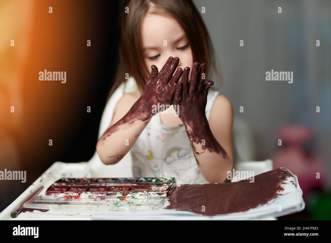 KId messy with paint via coloring her hands Stock Photo - Alamy