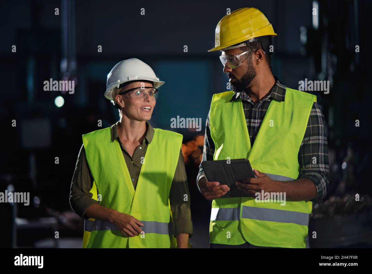 Portrait of industrial inspectors doing a general check up indoors at ...