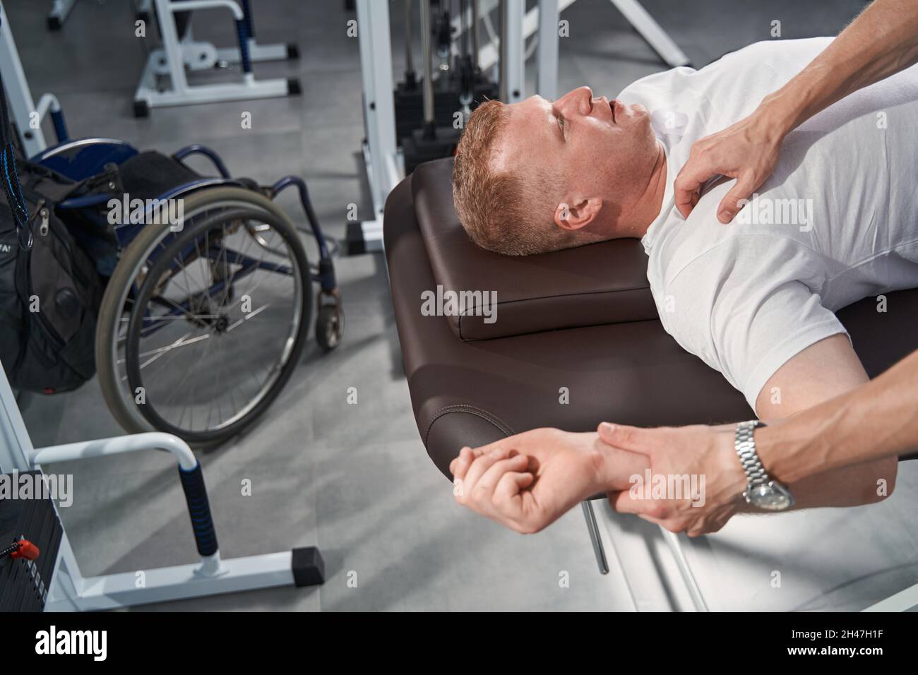 Close up patient doing hand stretching exercise on massage table Stock ...