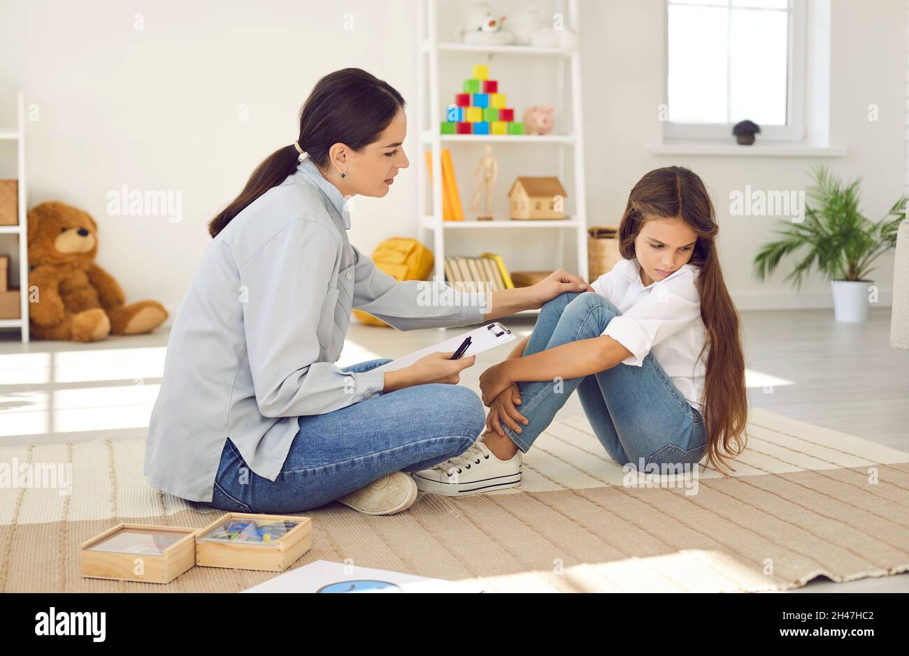 Psychologist or therapist helping sad child cope with problems, stress ...