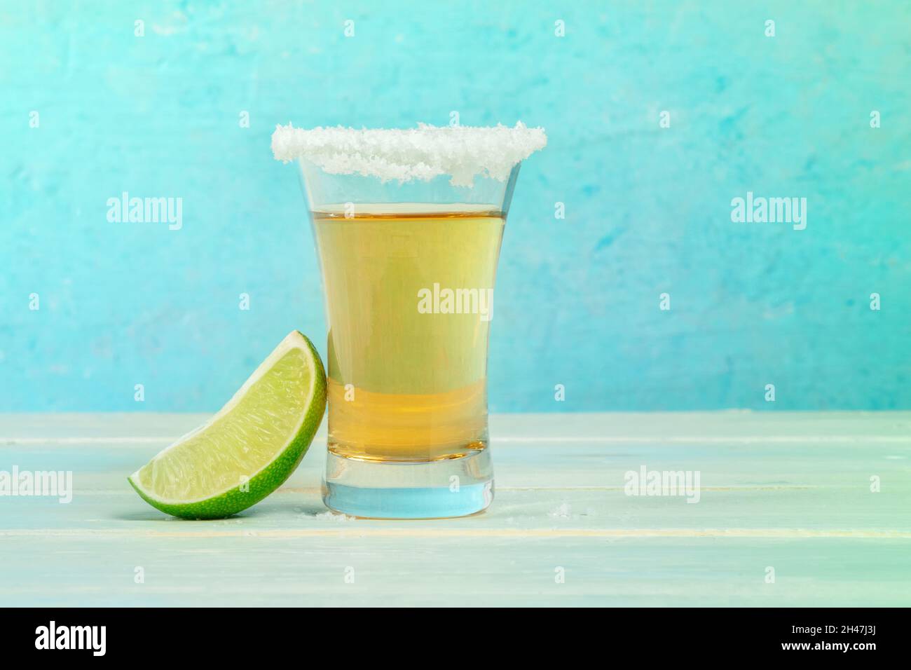 Tequila shot with lime, a Mexican alcohol drink on a teal blue ...