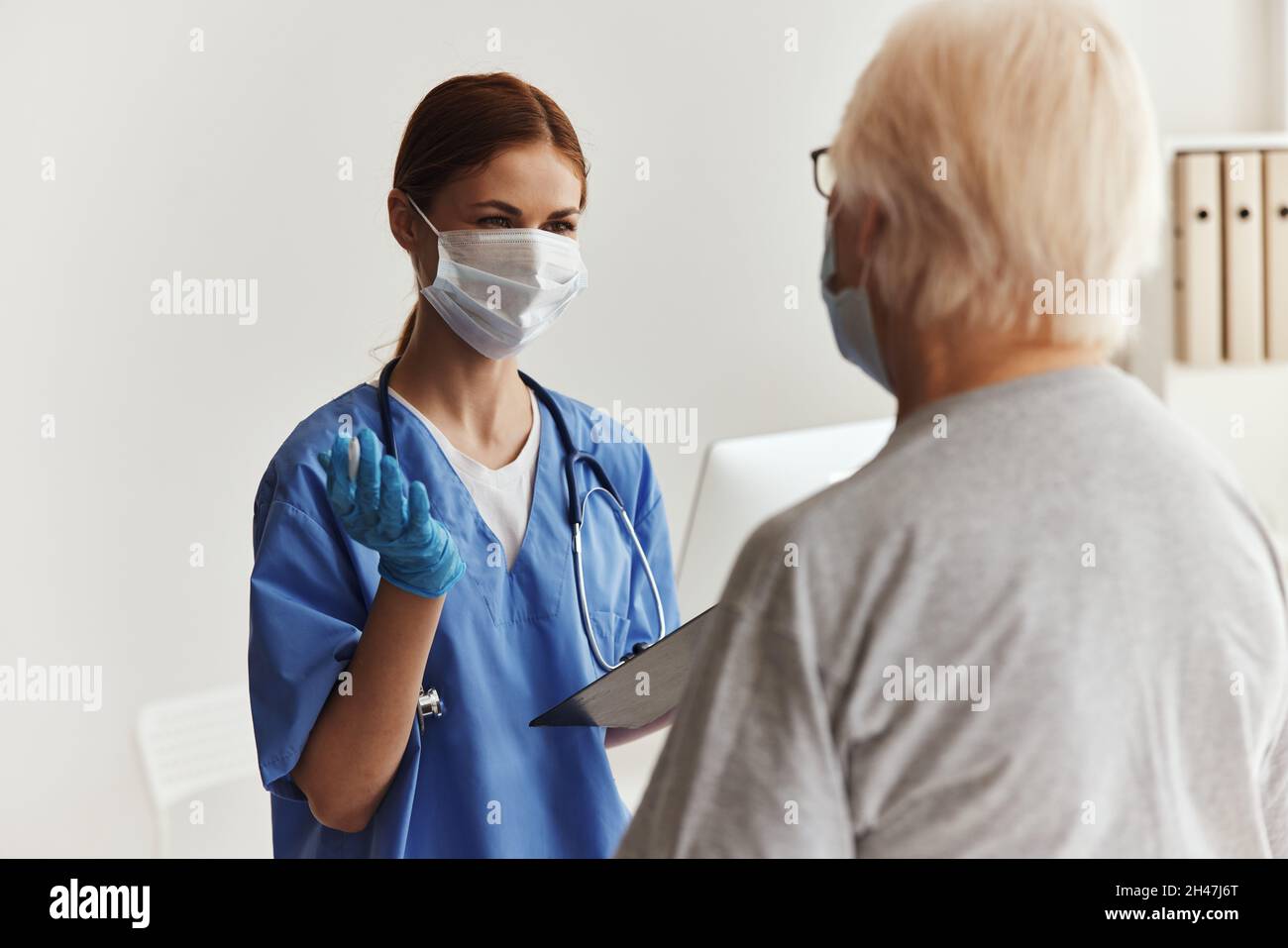 nurse and patient discussion treatment Stock Photo - Alamy
