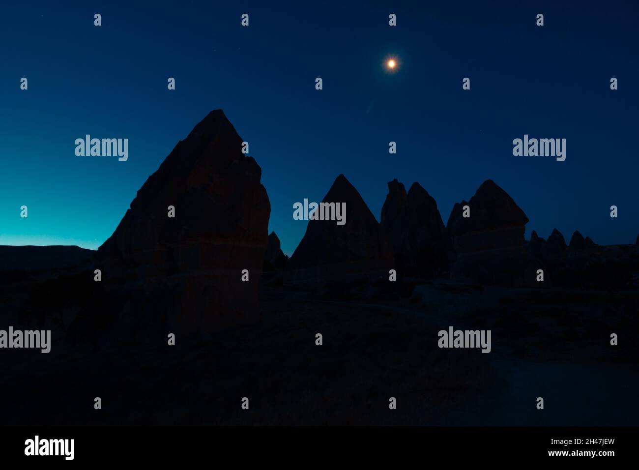 Silhouette of Fairy Chimneys or Peri Bacalari and Moon at Sunrise ...