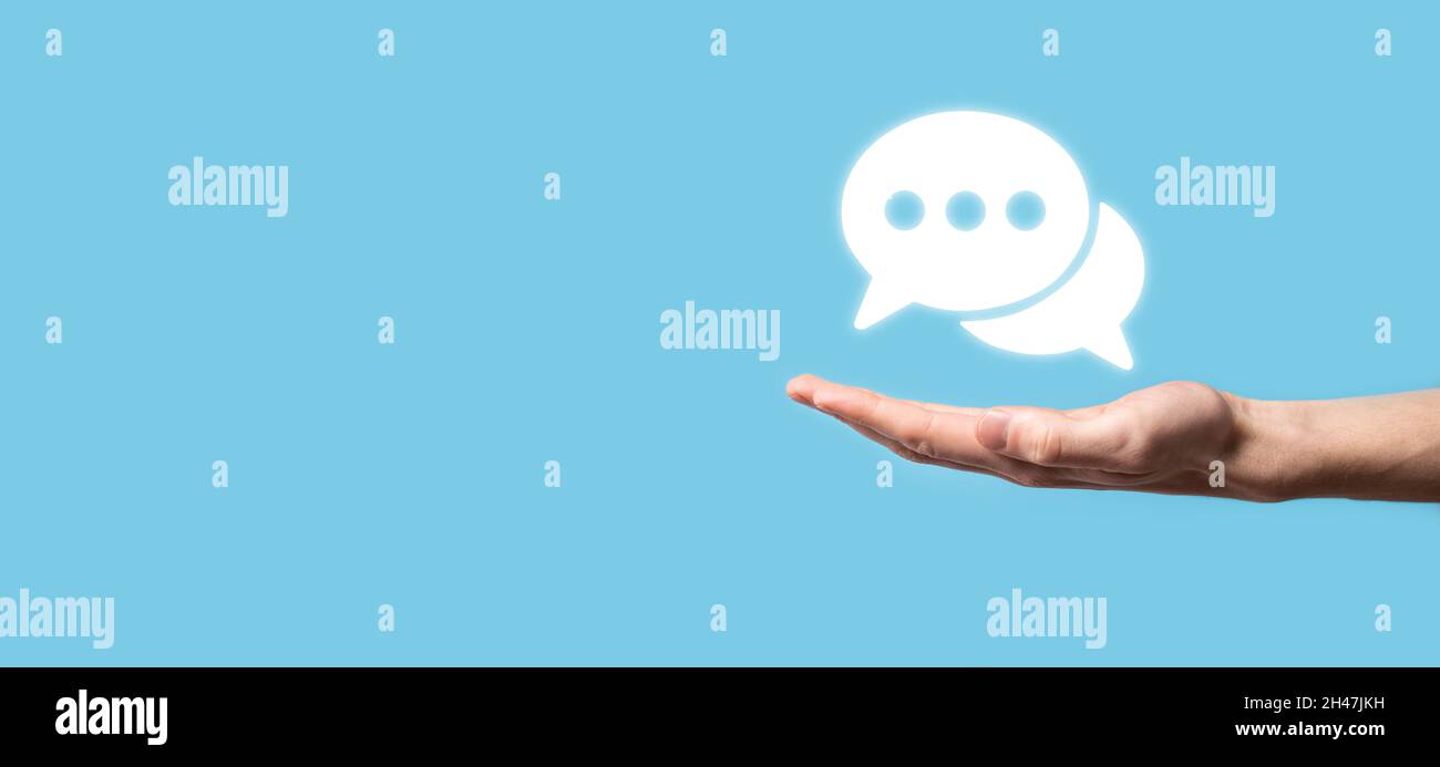 Businessman holding a message icon, bubble talk notification sign in ...