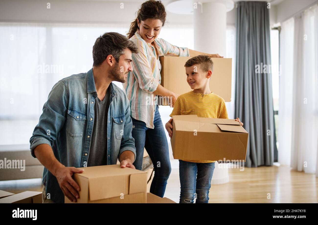 Family unpacking cardboard boxes at new home Stock Photo - Alamy