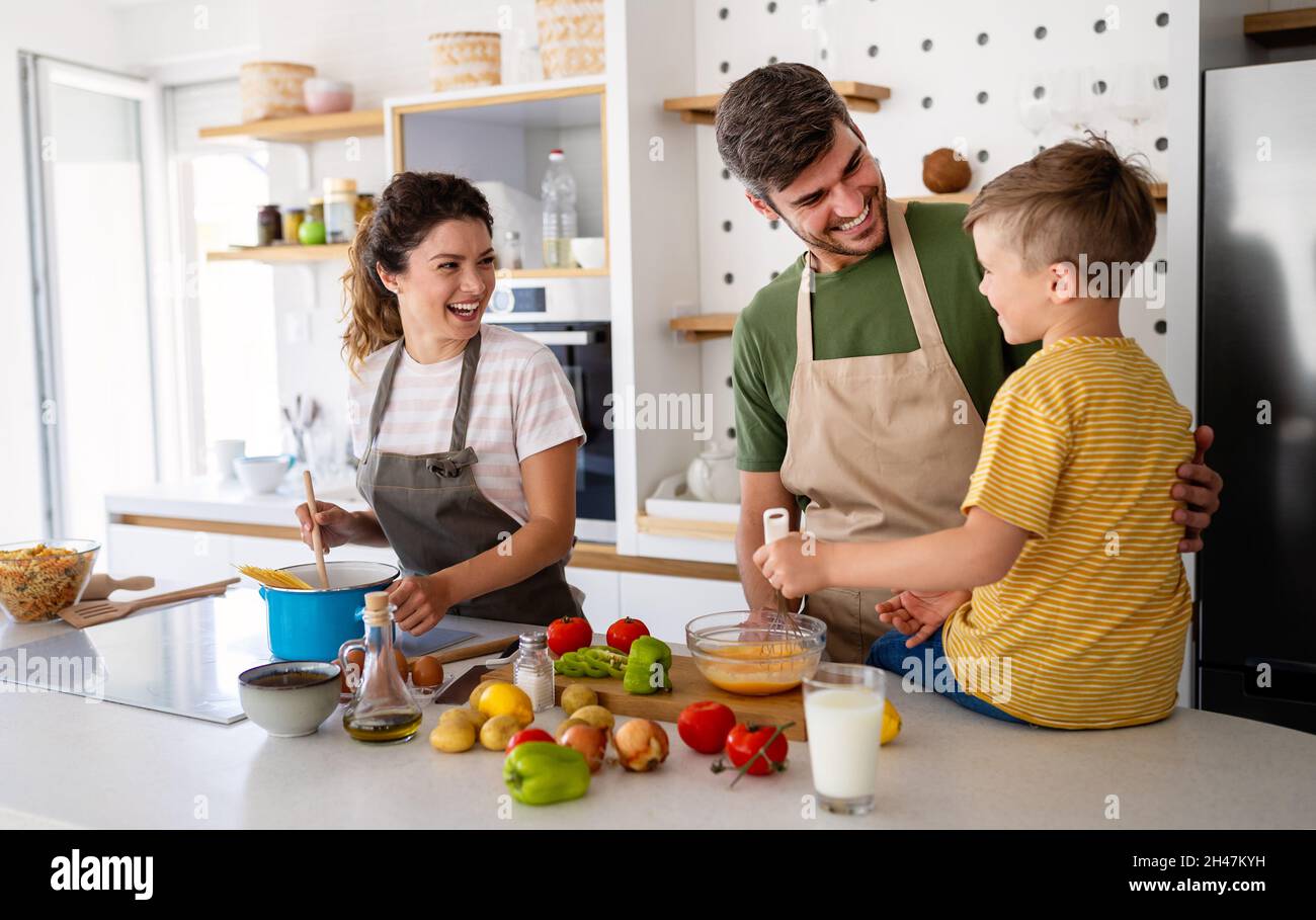 Happy family in the kitchen having fun and cooking together. Healthy ...