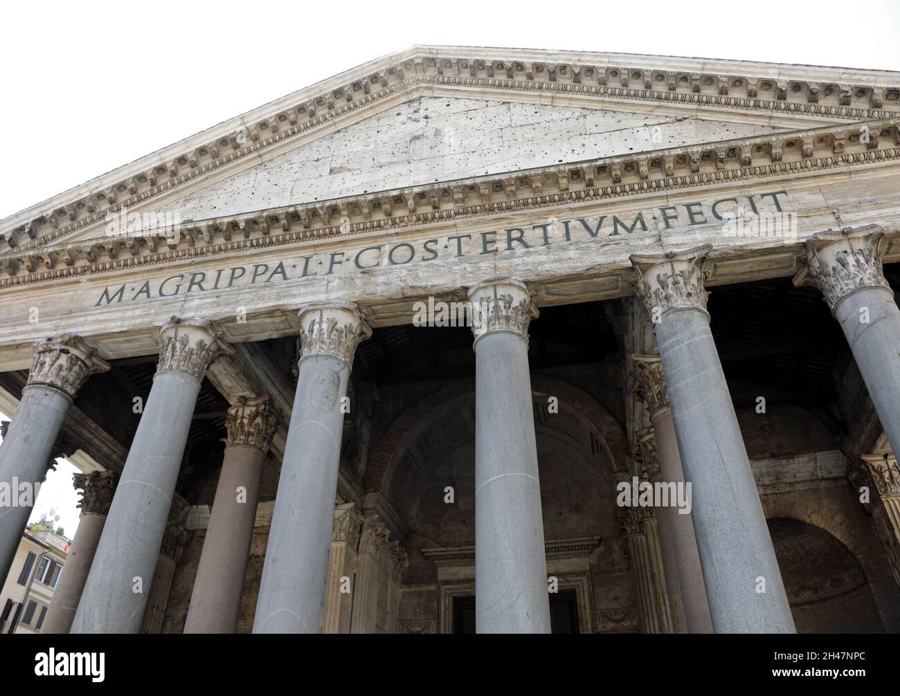 ancient temple Pantheon with the columns seen from below and the Latin ...