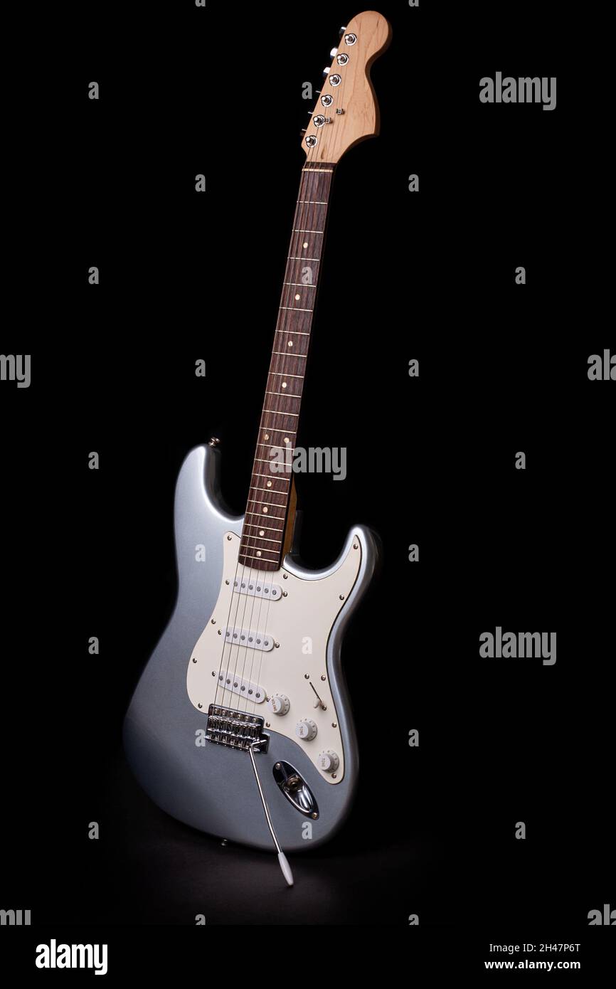Silver electric guitar isolated on black background Stock Photo - Alamy