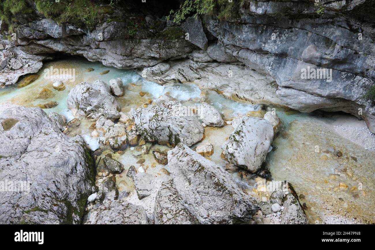 spring water flowing between the rocks of the mountain stream Stock ...
