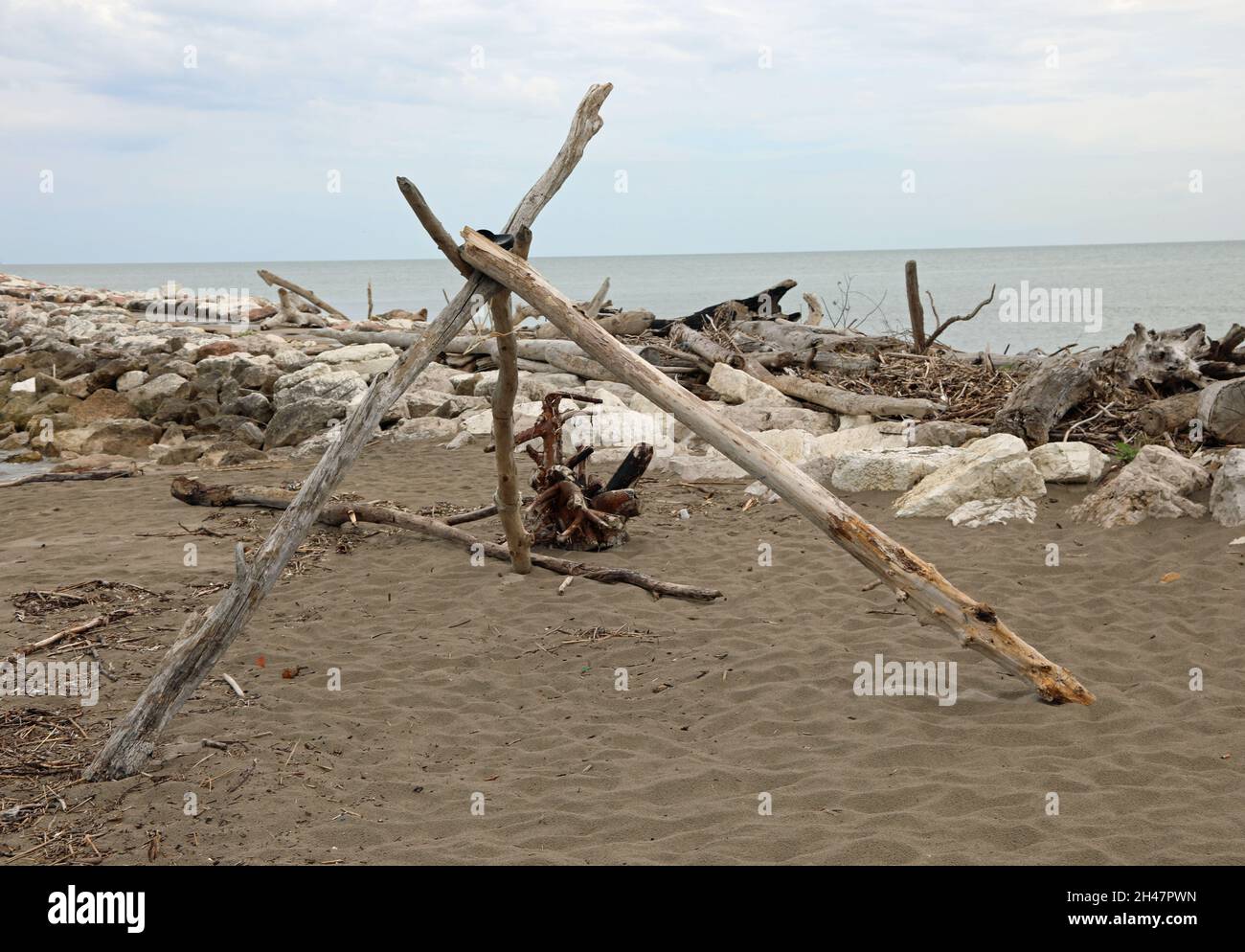 abandoned log cabin made of pyramid-shaped logs on the shore of the ...