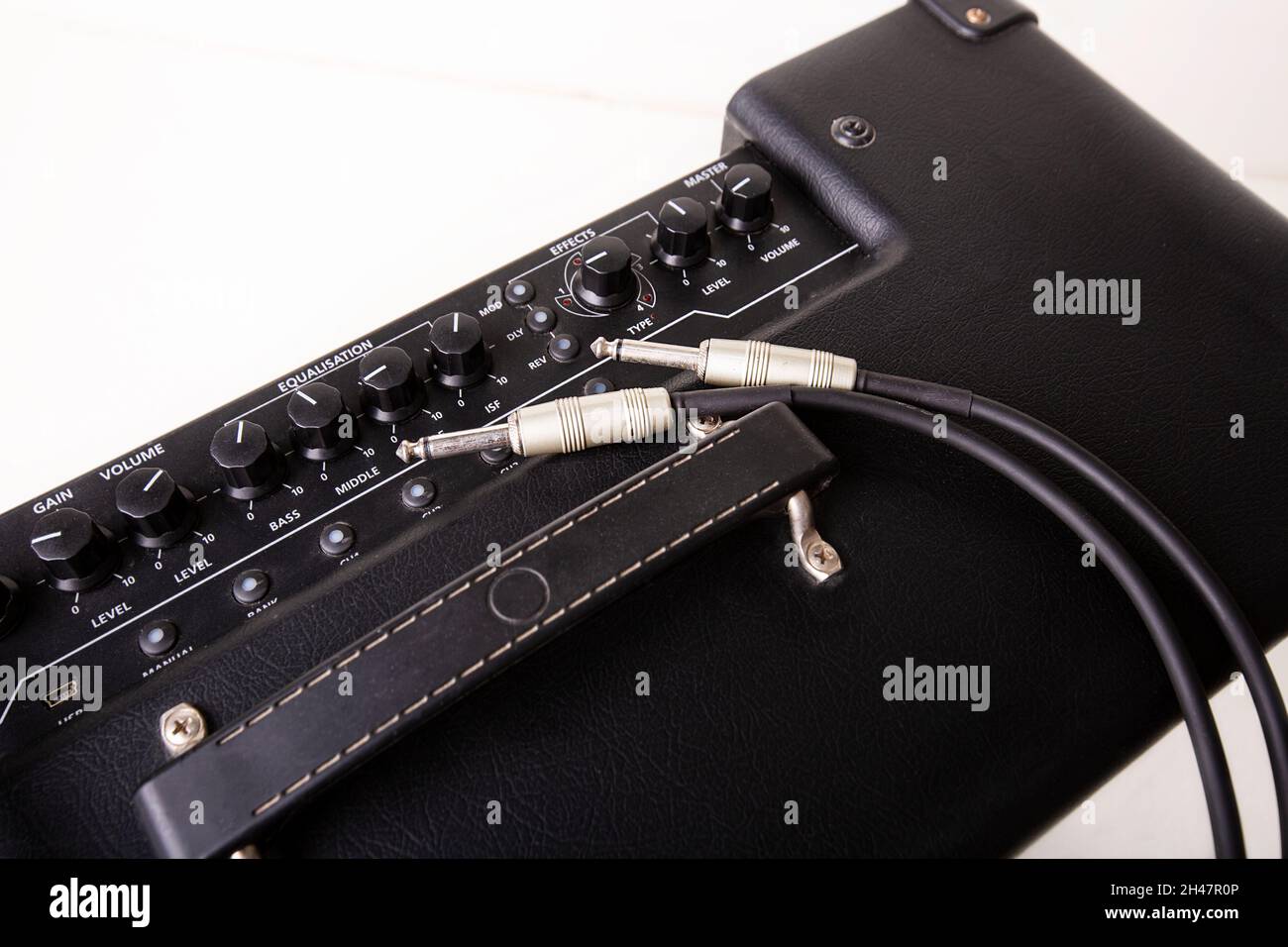 Black electric amplifier with cable on white background Stock Photo - Alamy