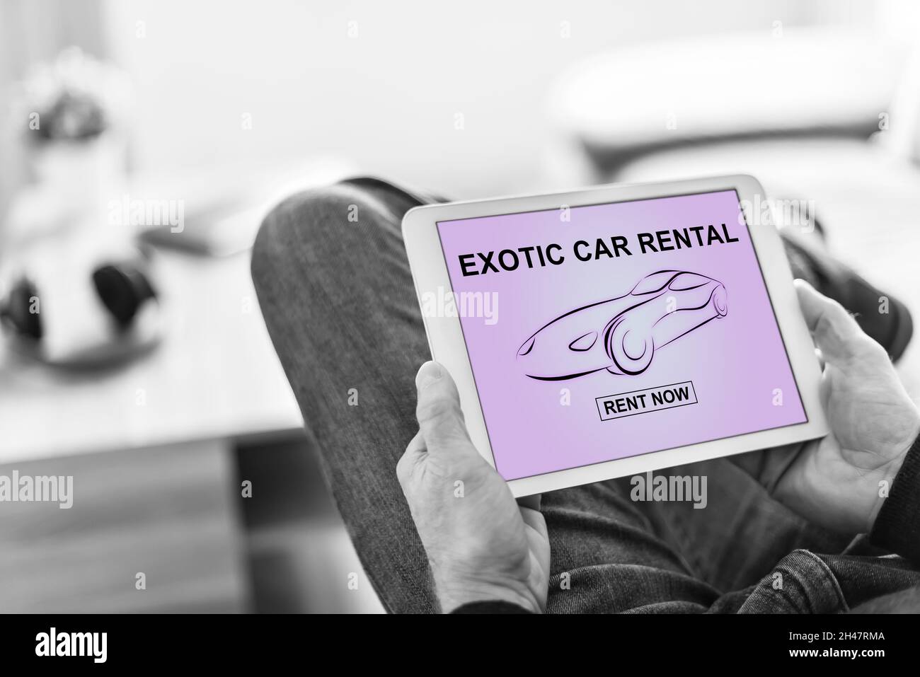 Tablet screen displaying an exotic car rental concept Stock Photo - Alamy