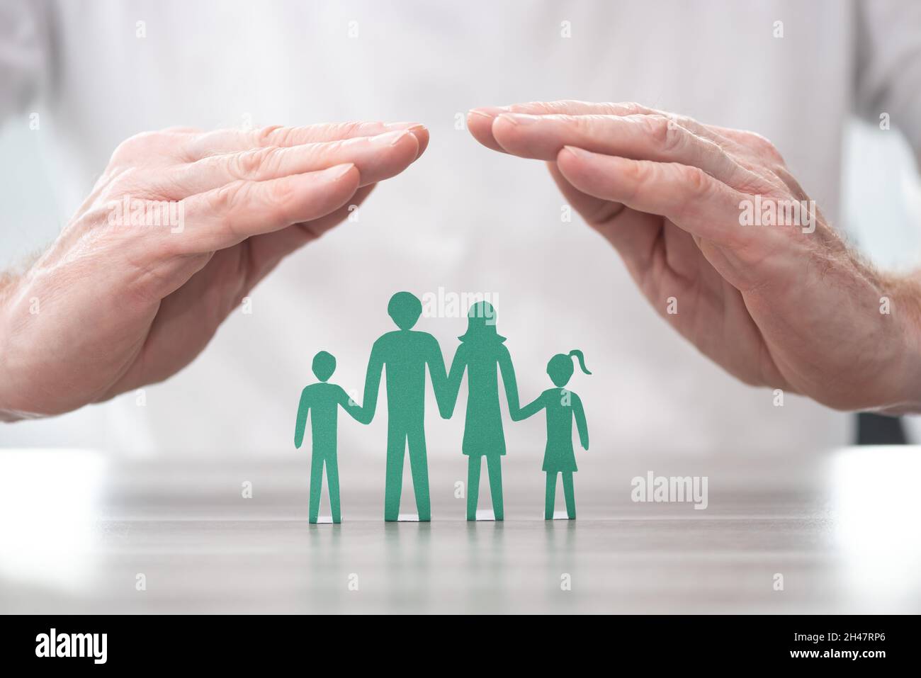Family protected by hands - Concept of life insurance Stock Photo - Alamy