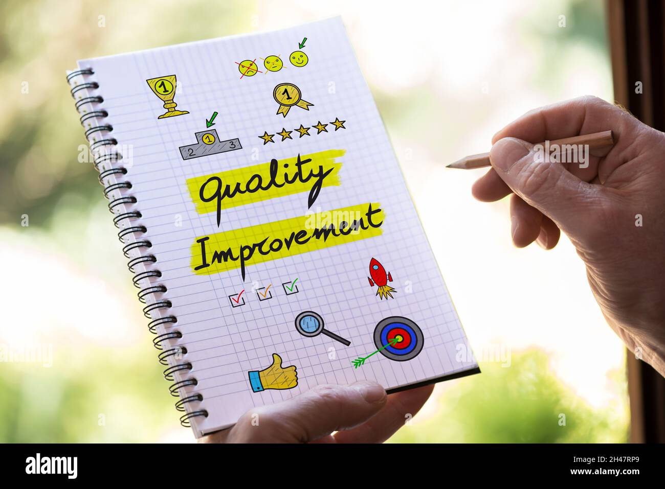 Hand drawing quality improvement concept on a notepad Stock Photo - Alamy