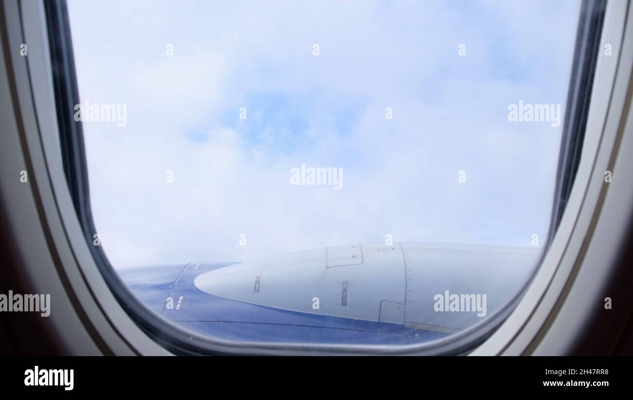 Clouds and sky as seen through window of an aircraft. Concept flying ...
