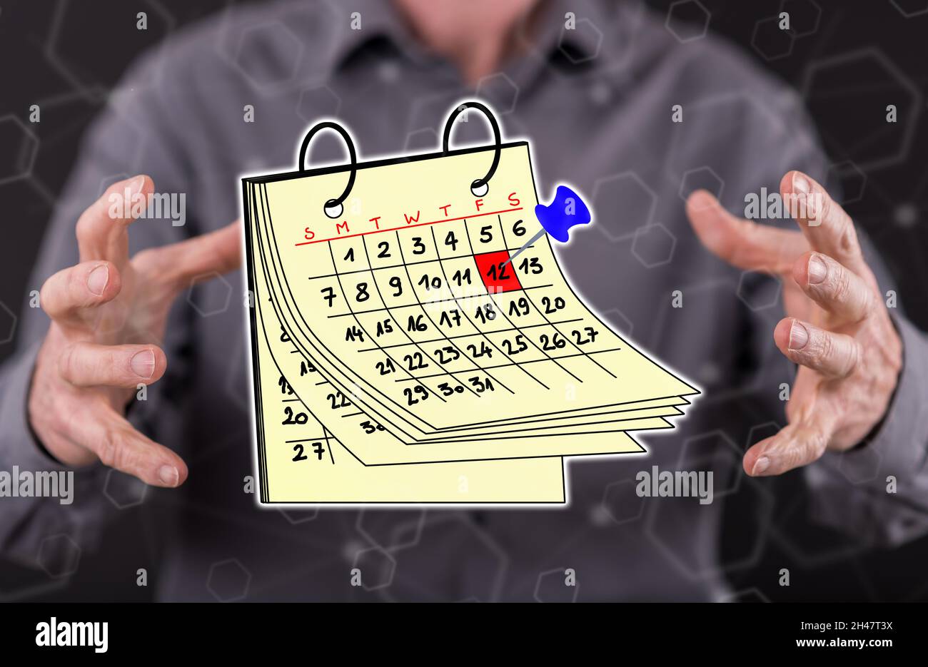 Calendar concept between hands of a man in background Stock Photo - Alamy