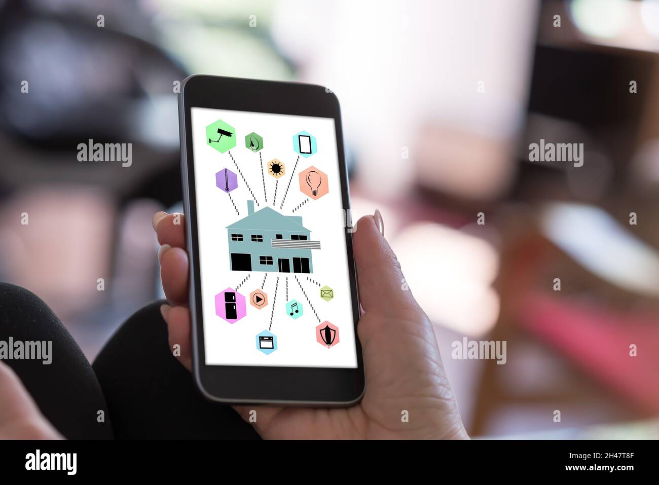 Hand holding a smartphone with smart home automation concept Stock ...