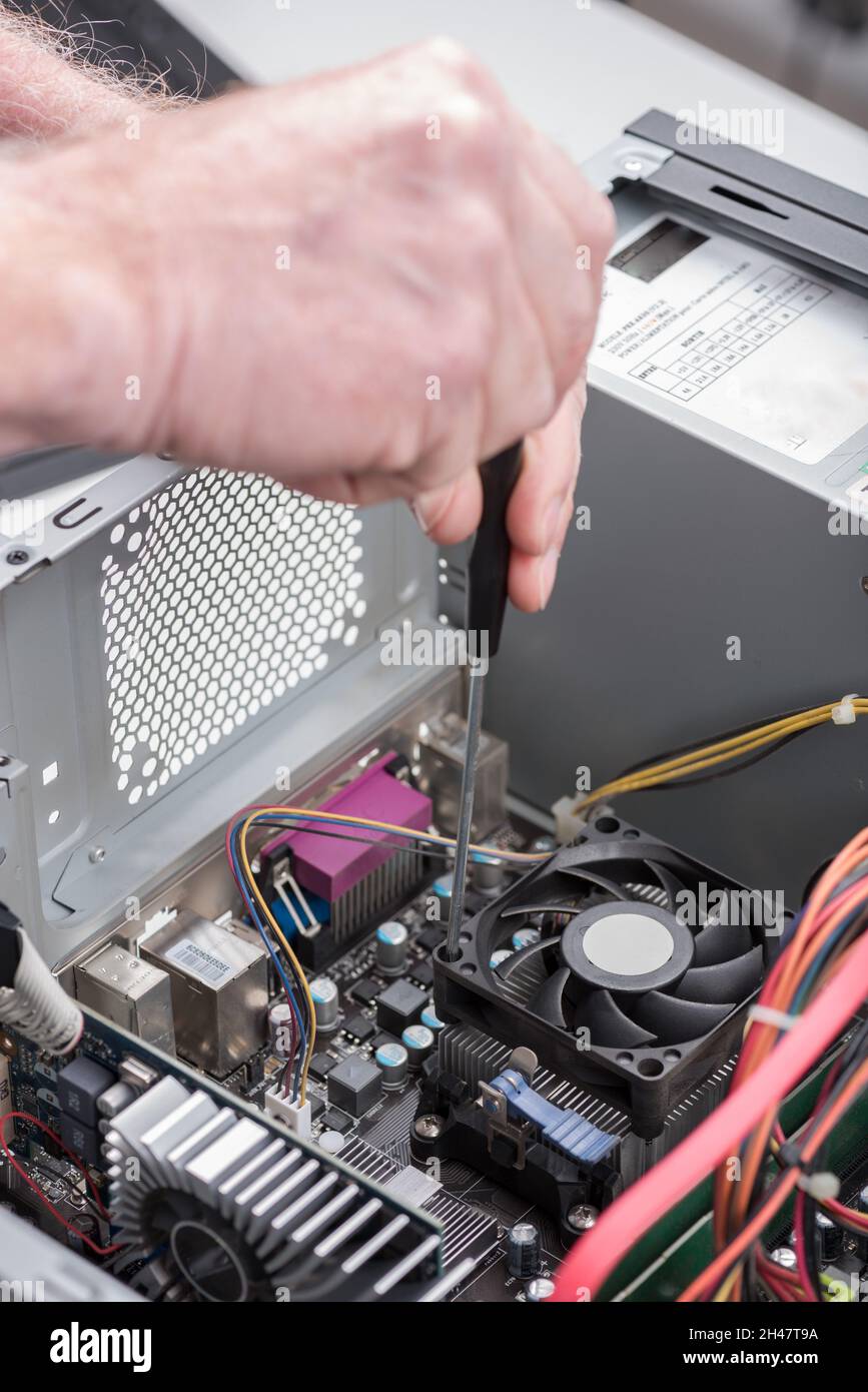 Hand repairing a computer Stock Photo - Alamy