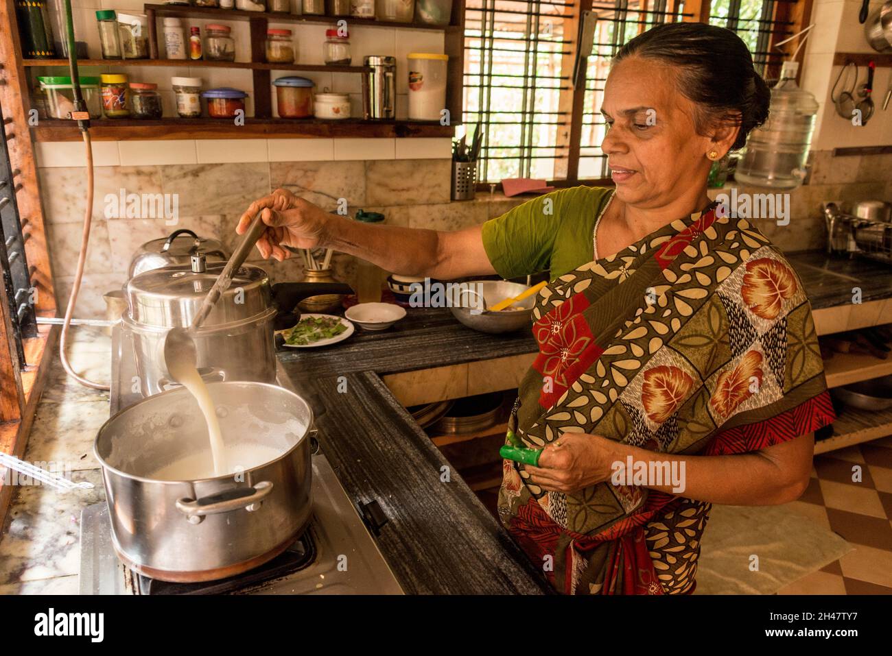 An Indian cook busy preparing a Kerala lunch for hotel guests in the ...