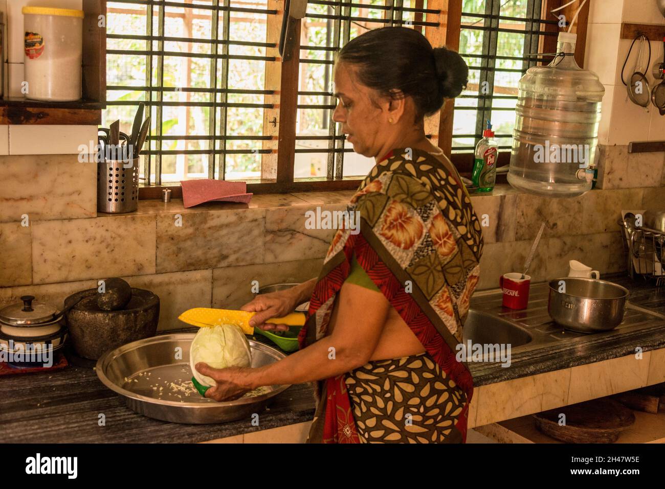 An Indian cook busy preparing a Kerala lunch for hotel guests in the ...