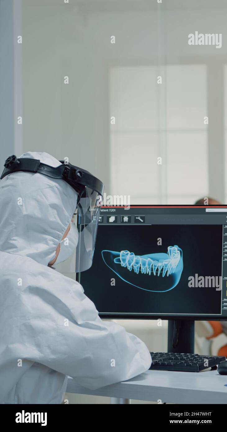 Orthodontists analyzing virtual teeth animation at oral clinic desk ...