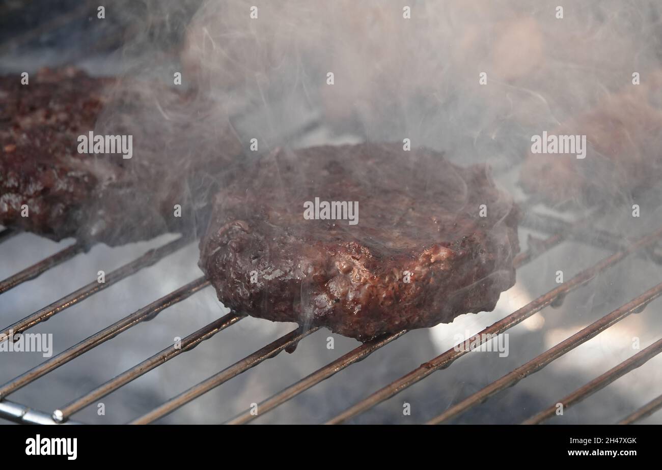 Closeup shot of a beef burger meat on the BBQ Stock Photo - Alamy
