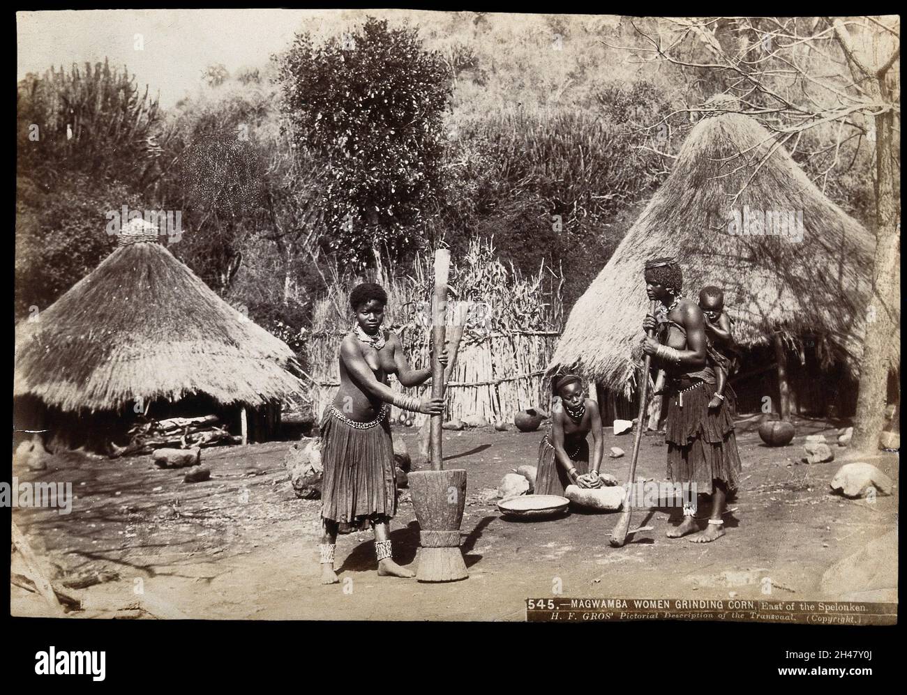South Africa: Magwamba women grinding corn outside mud huts; one woman ...