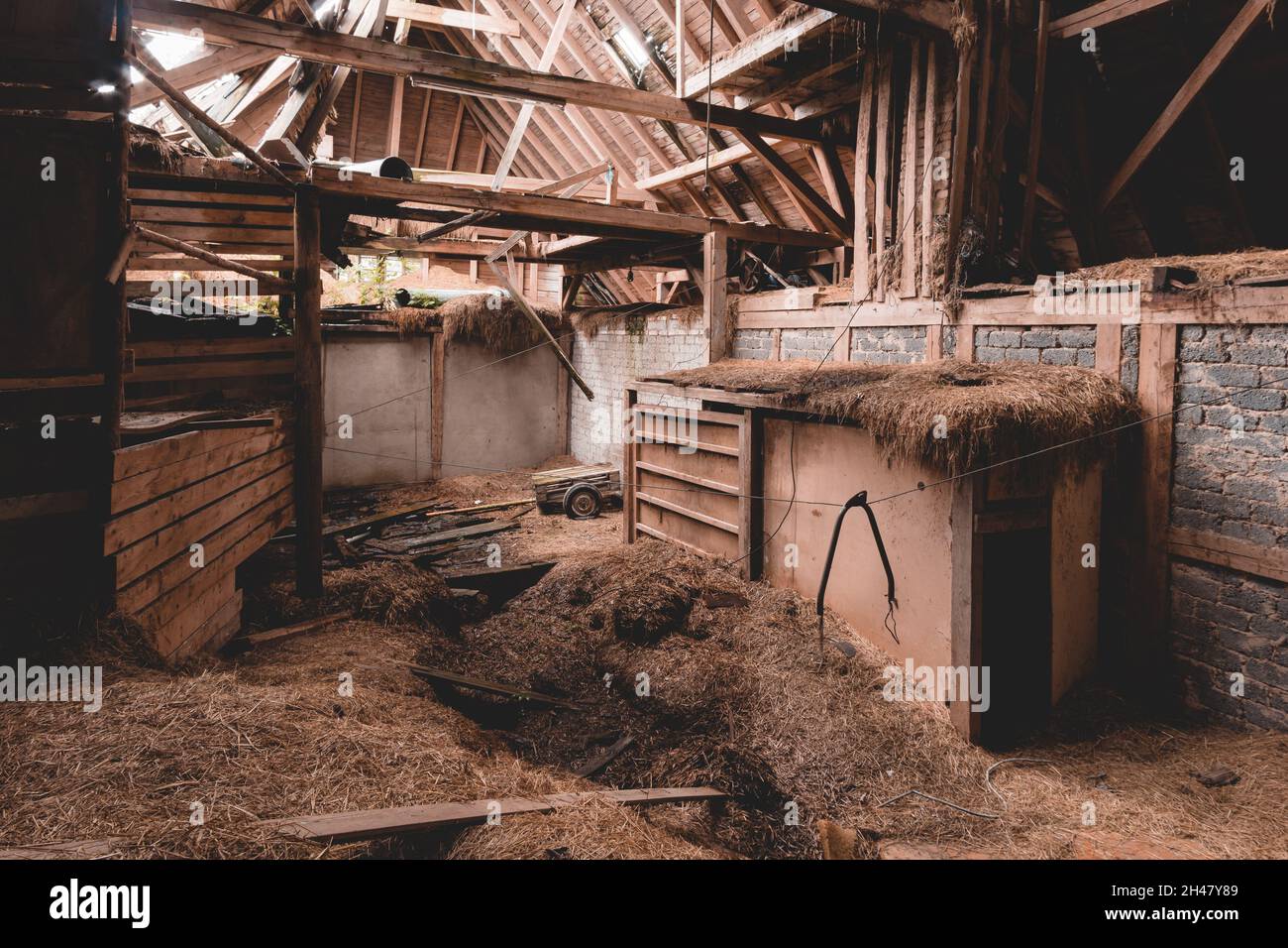 An old, collapsed hay barn, an abandoned farm, lost and decayed ...