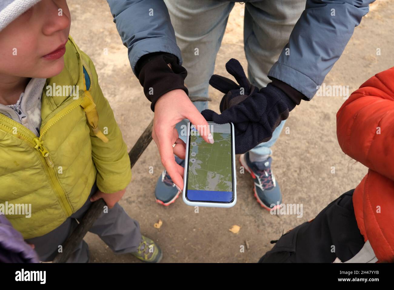 From above of crop unrecognizable female demonstrating map on screen of ...