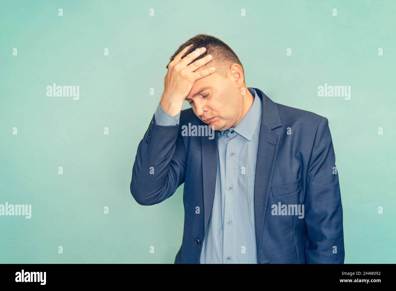 Businessman frustrated. Sign face palm. a man in a blue jacket is ...