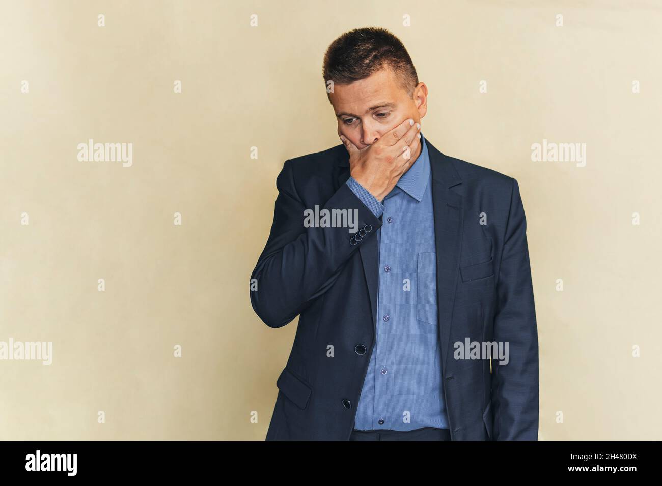 Confusion, Men, Business. a man holds his mouth with his hands an ...