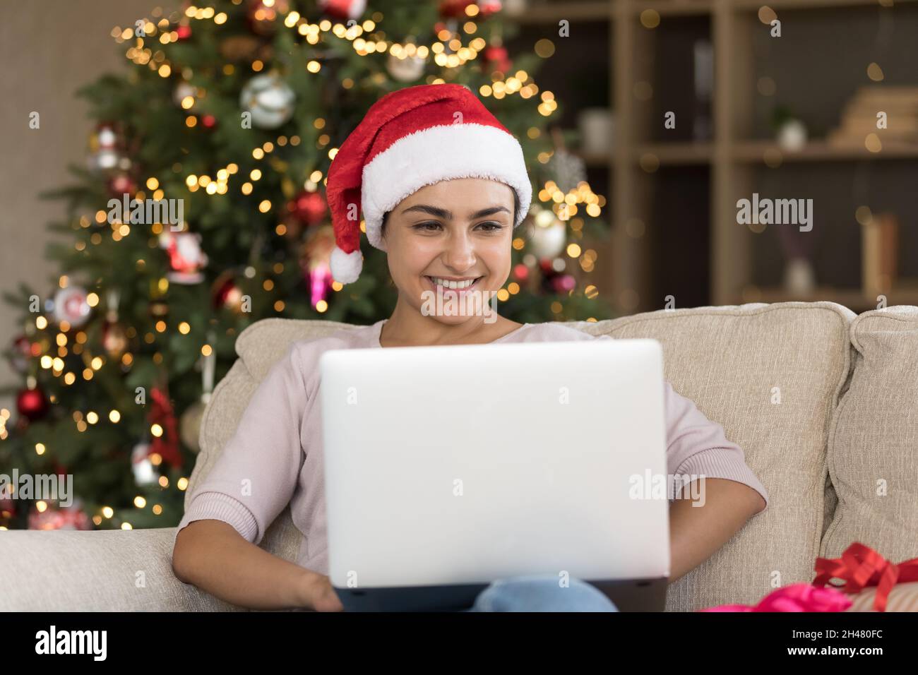 Happy beautiful young Indian woman using computer Stock Photo - Alamy