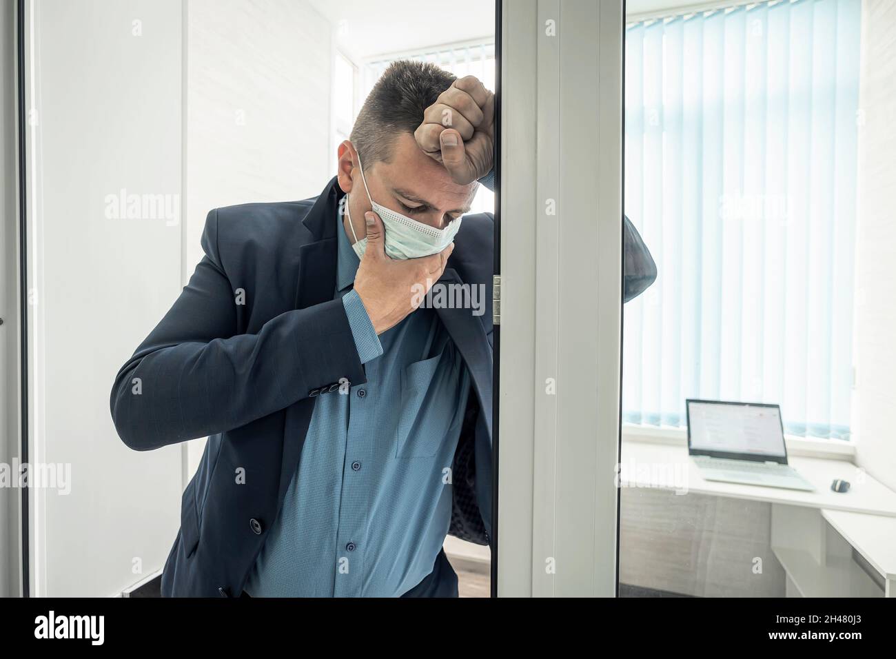 Office worker with coronavirus symptoms on background office. The ...