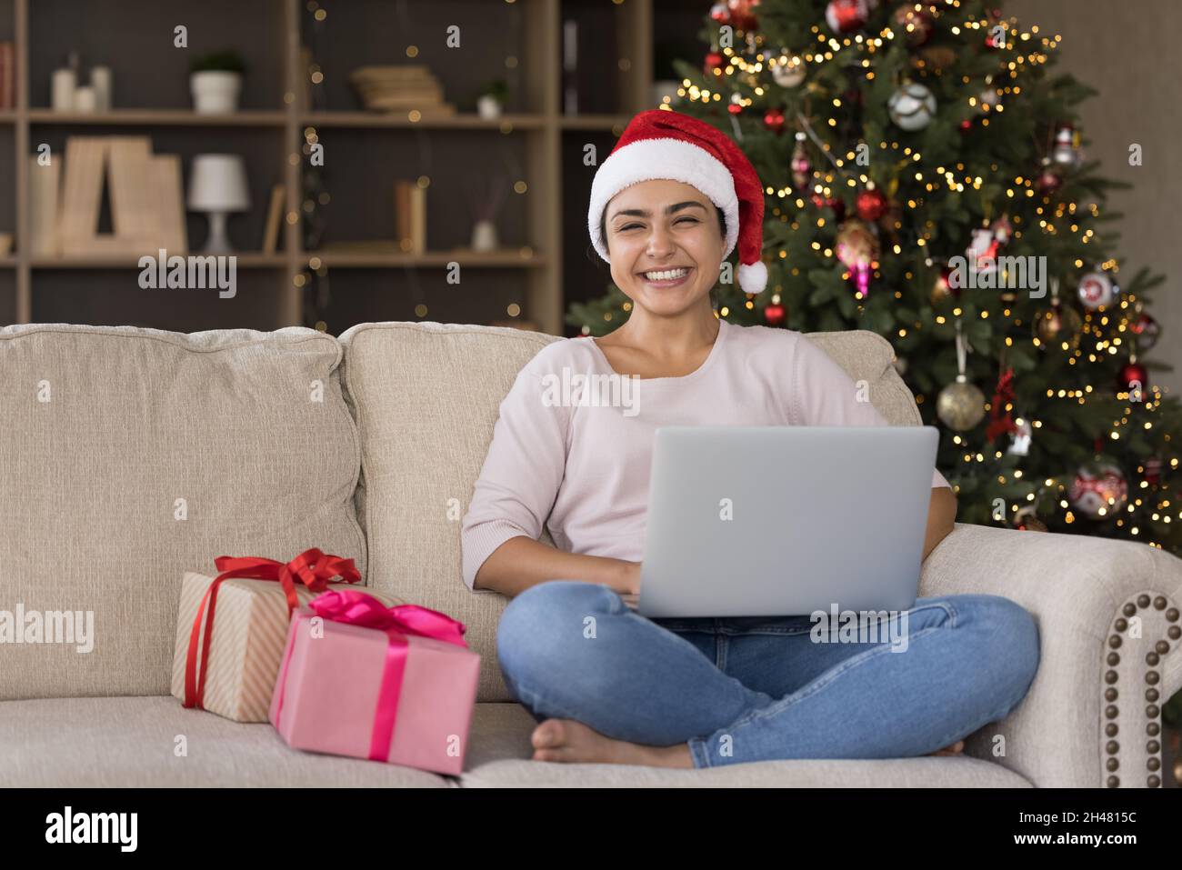 Happy millennial Indian woman using computer at home Stock Photo - Alamy