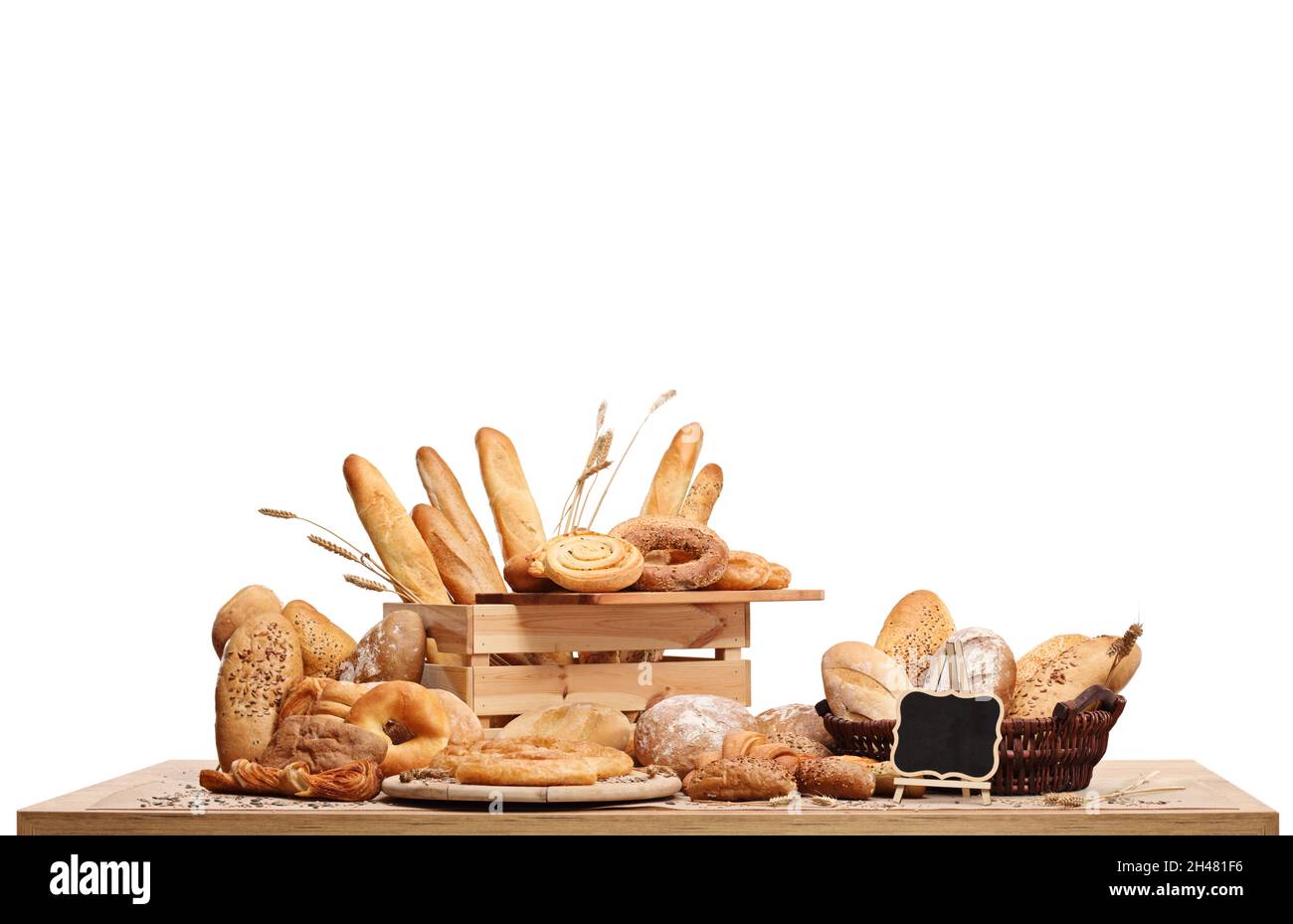 Variety of bread loaves on a wooden table isolated on white background ...