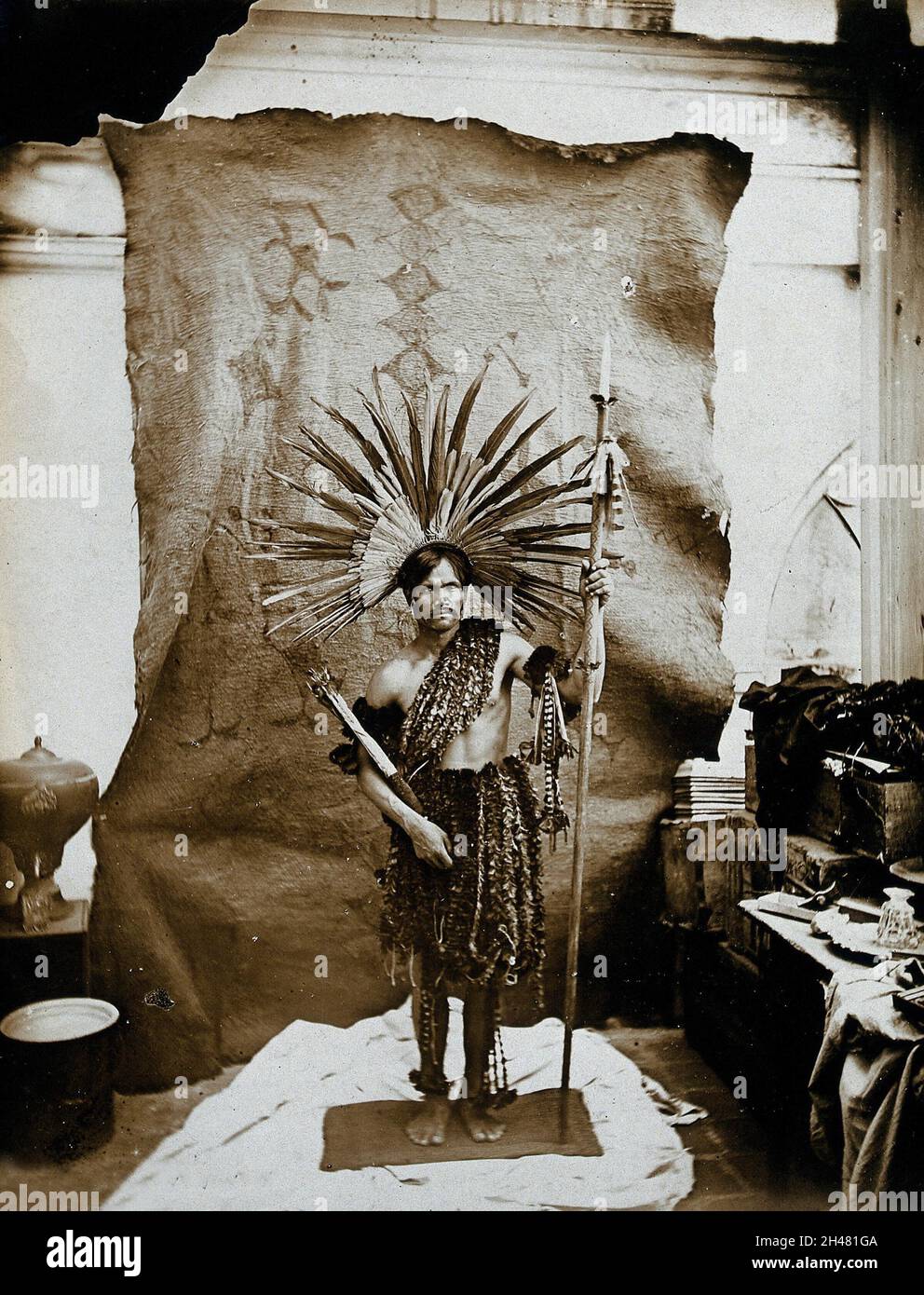 A man of an Amazonian tribe, holding a spear and wearing a feathered ...