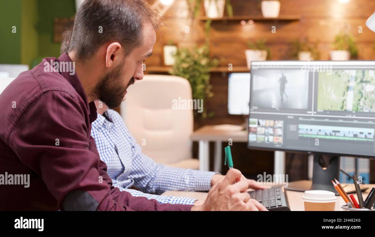 Team of video editors analyzing film montage after editing visual ...