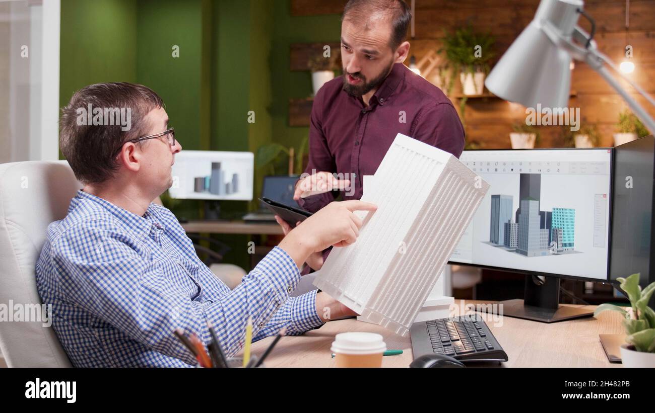 Architects Team Analyzing Building Maquette Discussing Architectural Prototype Structure Working