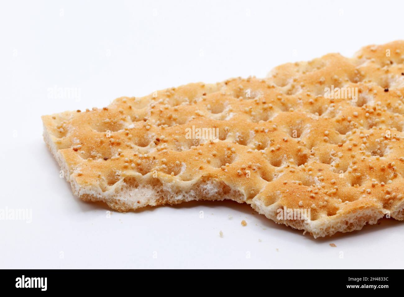 hard crispbread with crumbs and seeds on white background Stock Photo ...