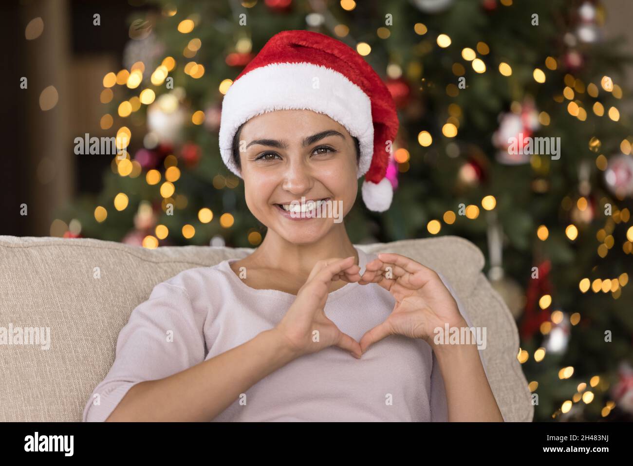 Happy pretty millennial Indian woman showing heart symbol Stock Photo ...