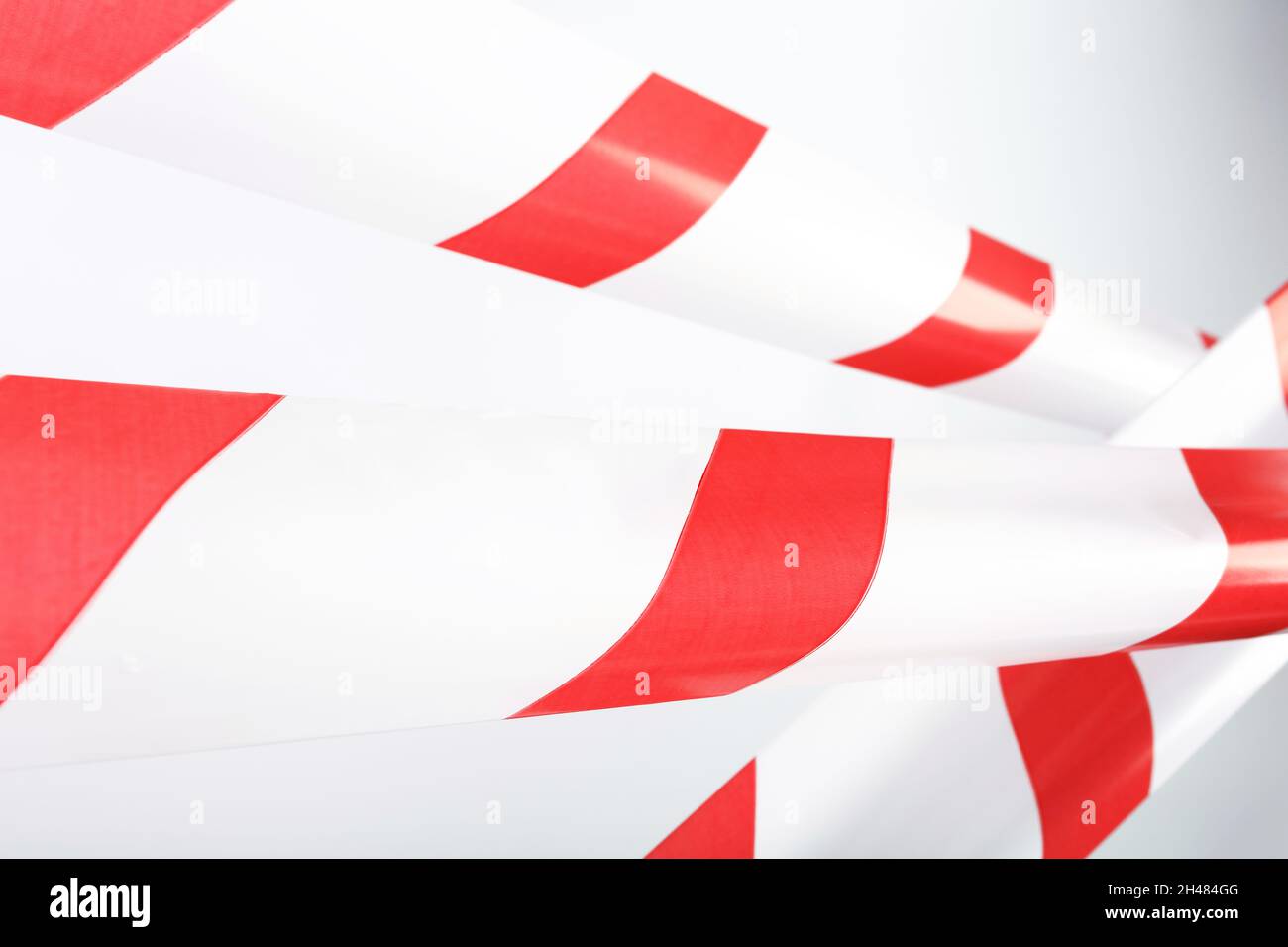 The tape is red and white for fencing danger on a white background ...