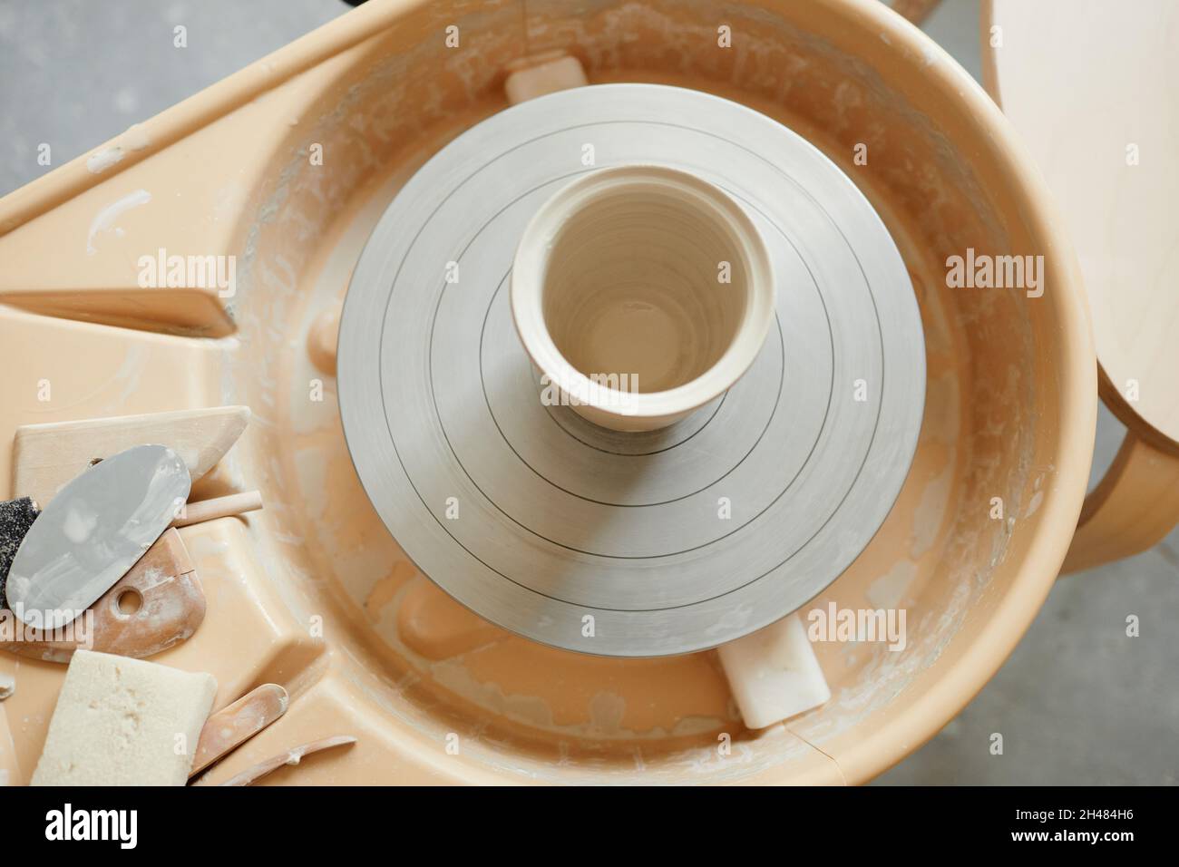 Top view background image of ceramic mug on pottery wheel in workshop ...