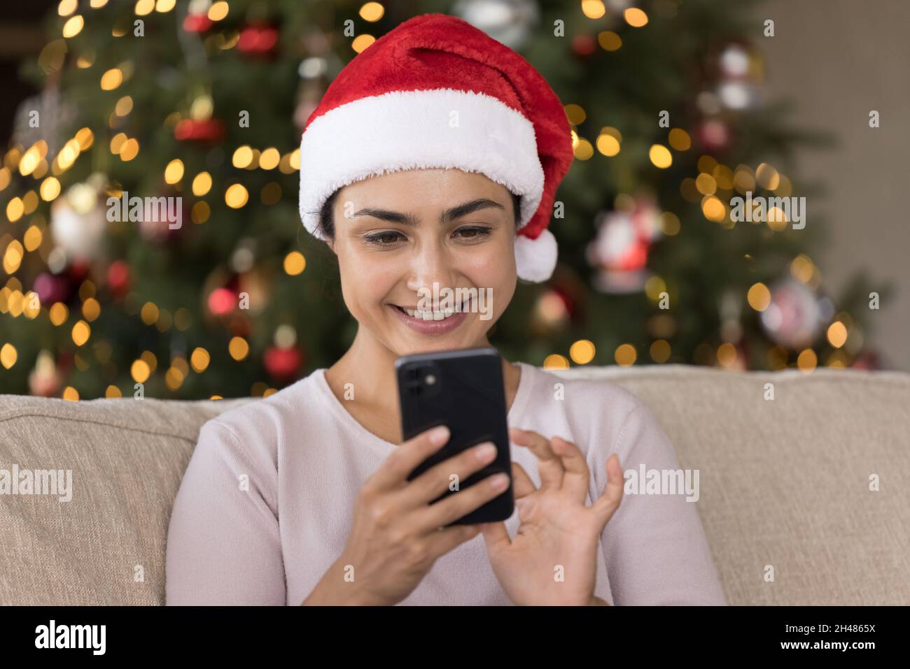 Smiling young Indian woman reading congratulations in cellphone Stock ...