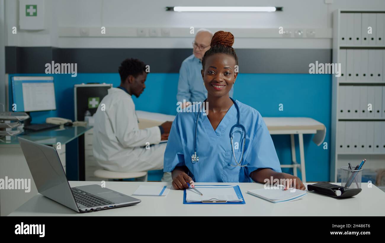 Close up of woman working as nurse sitting at desk and reading ...